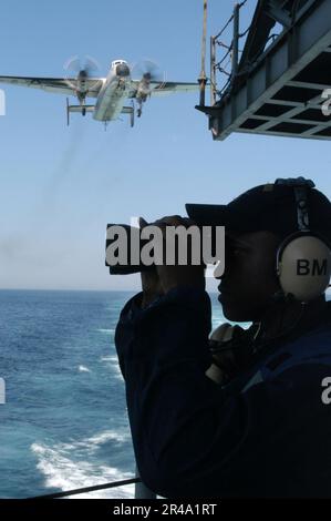 US Navy Seaman Apprentice stands helmsman watch during a general ...