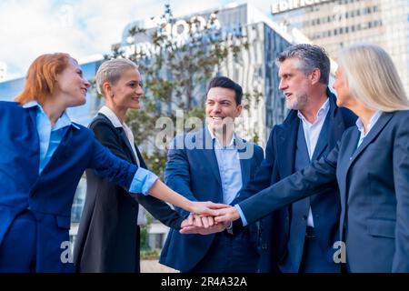 business team with hands clasped together Stock Photo - Alamy