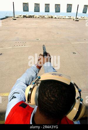 - A Sailor fires a 9mm pistol during a qualification course aboard the ...