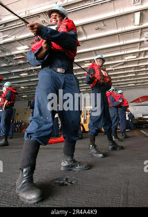 US Navy Deck Department crew members, assigned to the Nimitz-class ...