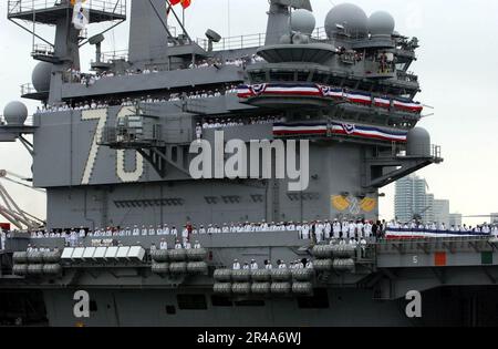 Crew members man the rails aboard the guided missile destroyer USS ...