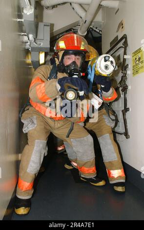 A U.S. Navy firefighter aboard the USS Ramage (DDG 61) uses a thermal ...