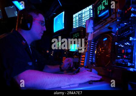US Navy Combat Direction Center (CDC) watch standers plot a chart ...