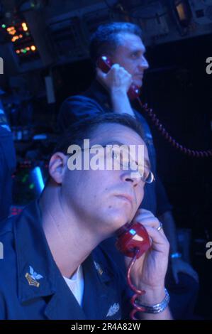 US Navy Operations Specialist 1st Class stands Combat Information ...