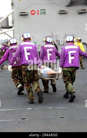 US Navy Crew members participate in a Foreign Object Damage (FOD) walk ...
