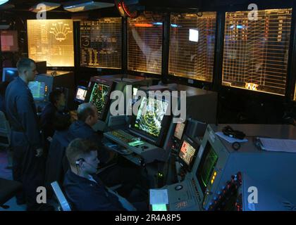 Three sailors man their stations in the carrier air traffic control ...