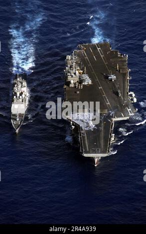 USS Vincennes (CG 49) and USS Kitty Hawk (CV 63) steam side-by-side ...