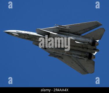 An F-14D Tomcat conducts a high speed flyby causing vapor to form. U.S ...
