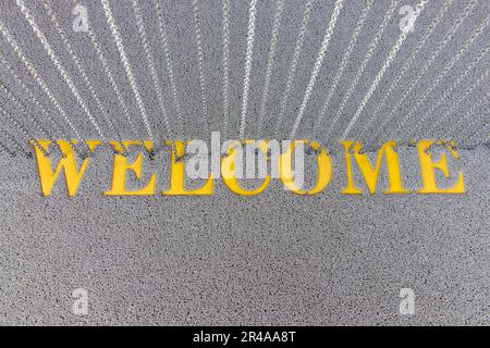 The inscription Welcome on a carpet under the hanged chains Stock Photo ...
