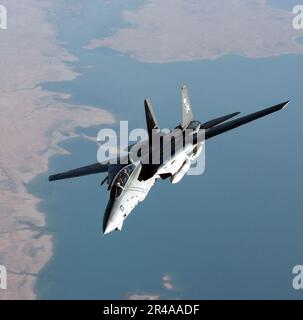 Three Fighter Squadron 103 (VF-103) F-14A Tomcat aircraft sit armed and ready on the flight deck ...