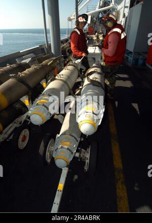 US Navy Aviation Ordnanceman prepare MK-76 practice bombs to be issued ...