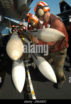 Three Fighter Squadron 103 (VF-103) F-14A Tomcat aircraft sit armed and ready on the flight deck ...