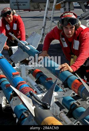 US Navy Aviation Ordnancemen move an AGM-65F Maverick air-to-surface ...