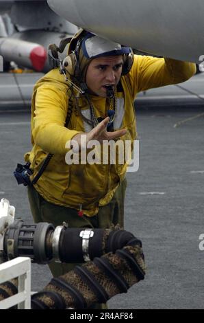 US Navy An aircraft handler aboard the Nimitz-class aircraft carrier ...