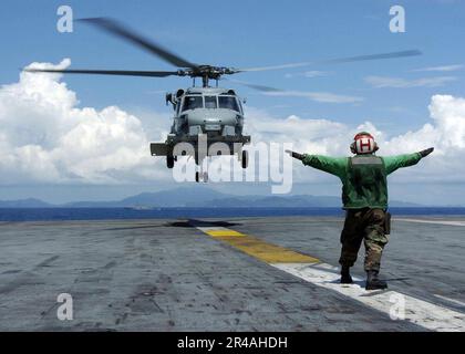 US Navy A Landing Signals Enlisted directs an SH-60B Seahawk assigned ...