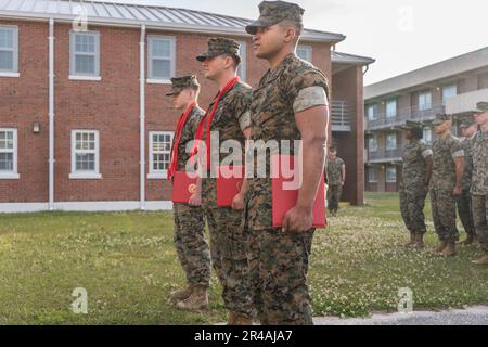 Marines hold their promotion warrants during a meritorious promotion ...
