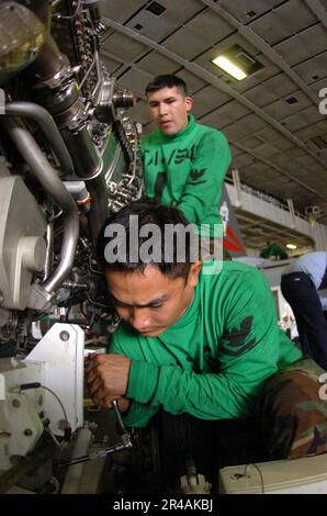 US Navy Aviation Machinist Mates inspect a 414 Bell Mouth aboard ...