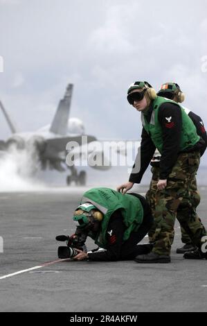 US Navy Photographer's Mate 1st Class Aviation Warfare right, instructs ...