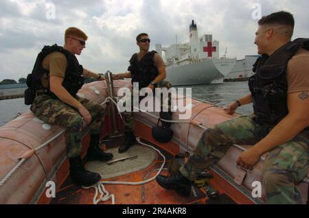 US Navy Master at Arms Second Class Heath Garcia drives a Rigged Hull ...