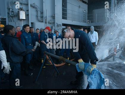 US Navy Sailor participate in a pipe patching exercise on the fantail ...