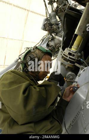 US Navy Aviation Electrician's Mate 3rd Class performs maintenance on ...