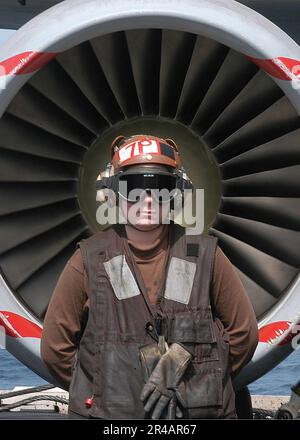 US Navy A Plane Captain stands by on the flight deck aboard the Nimitz ...