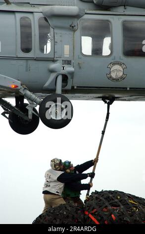 US Navy Chief Storekeeper left, assigned to Naval Expeditionary ...