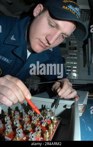 US Navy Electrician's Mate 3rd Class rewinds a vent coil aboard the ...