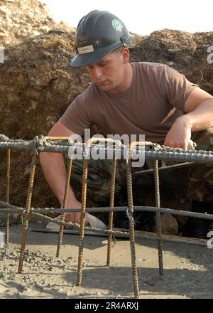 US Navy Navy Steel Worker 3rd welds a frame for a basketball goal at ...