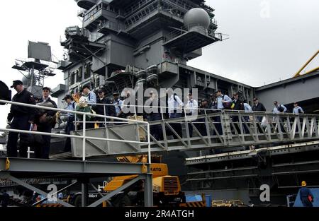 Sailors depart conventionally powered aircraft carrier USS Kitty Hawk ...