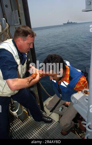 US Navy Senior Chief Boatswain's Mate supervises the safety of his ...