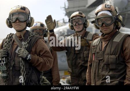 US Navy Squadron plane captains hold tie down chains used to tie down ...