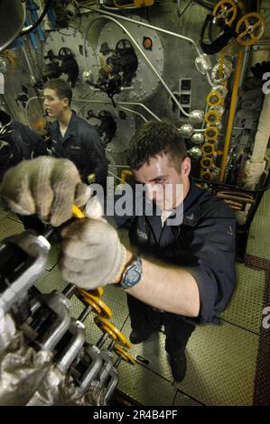 US Navy Machinist's Mate 3rd Class transfers liquid oxygen (LOX) into a ...