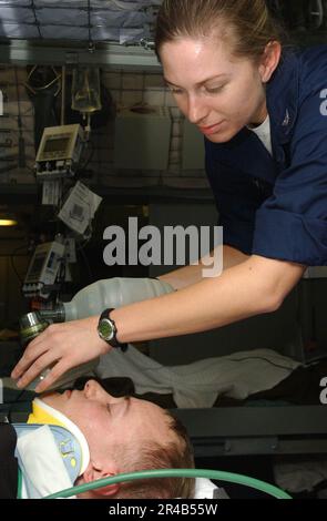 US Navy Dental Technician 3rd Class uses a vacuum to hold down teeth ...