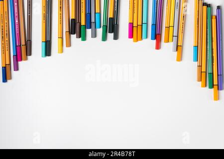Different coloured fineliners above, white background, copy space below ...