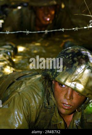 US Navy Utilitiesman 3rd Class and an Indonesian Marine take a break ...
