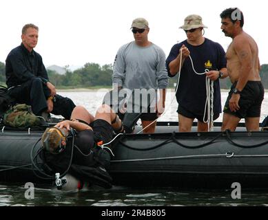 U.S. Navy diver enters the water for a mooring buoy inspection at ...