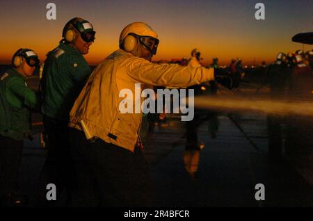 US Navy A fire fighting team works in the darkness to put out a ...