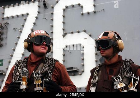 US Navy Squadron plane captains hold tie down chains used to tie down ...