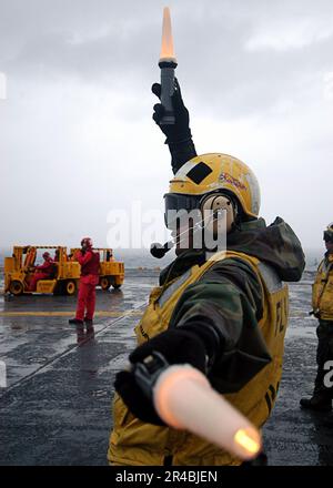 Boatswain's Mate directs SH-60 Seahawk helicopter from HSL-37 during ...