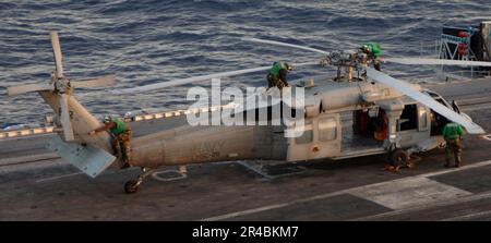 US Navy Sailors perform routine corrosion control maintenance on an SH ...
