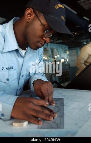 US Navy Quartermaster Seaman plots the ship's position before the ...