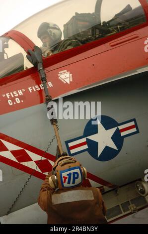 US Navy A Plane Captain hand wipes an E-2C Hawkeye in the hangar bay ...