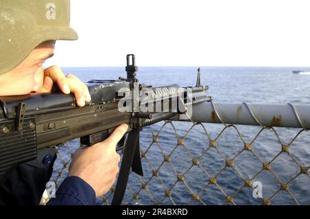 US Navy Torpedoman's Mate 2nd Class instructs a Sailor on the proper ...