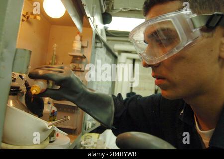 US Navy Engineman 3rd Class performs pre-operational checks on an ...