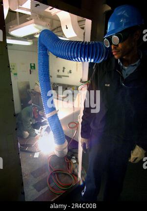 US Navy Electrician's Mate Fireman checks the fuse temperature on an ...