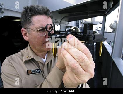 US Navy Senior Chief Quartermaster instructs several Sailors on the ...