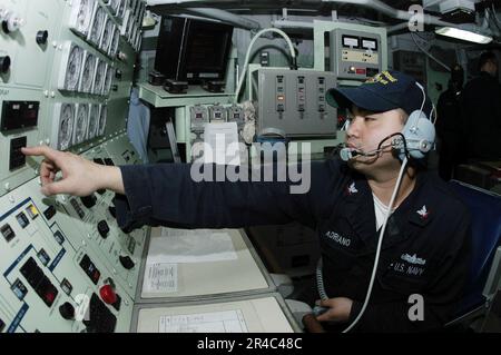 US Navy Electrician's Mate 3rd Class troubleshoots a fuse box with a ...