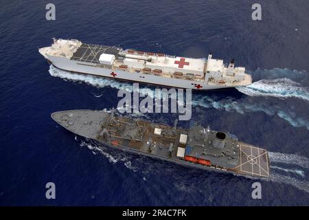 US Navy USNS Mercy performs an underway replenishment operation with ...