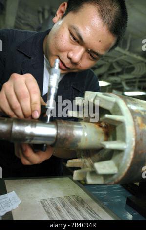 US Navy Machinery Repairman Fireman constructs a pump shaft aboard the ...